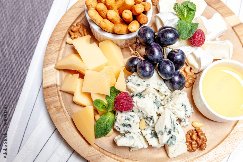 Board with different types of cheese. Cheeses mix set dor blu chedar ...