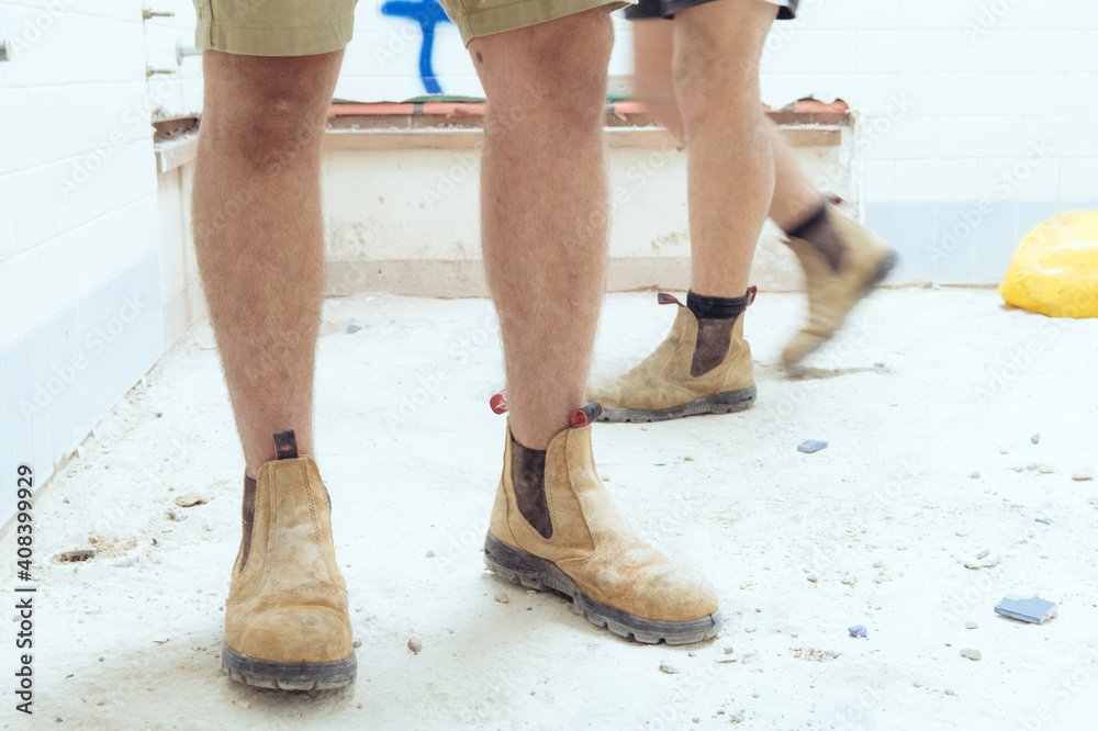 Tradesman wearing boots on construction site Stock Photo | Adobe Stock