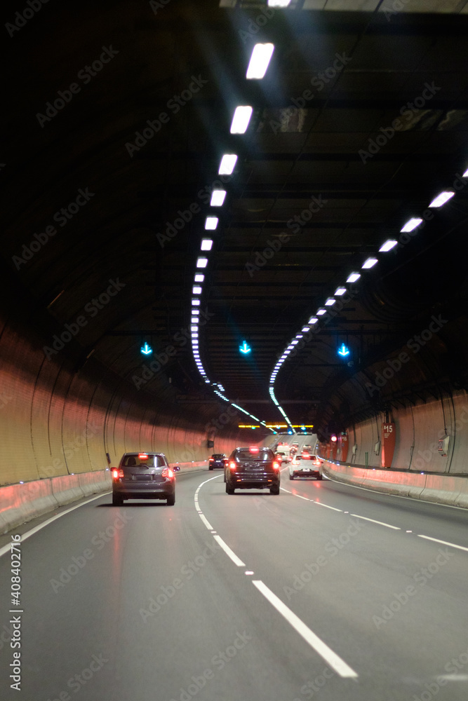 Cars travelling through city toll road underground tunnel Stock Photo ...