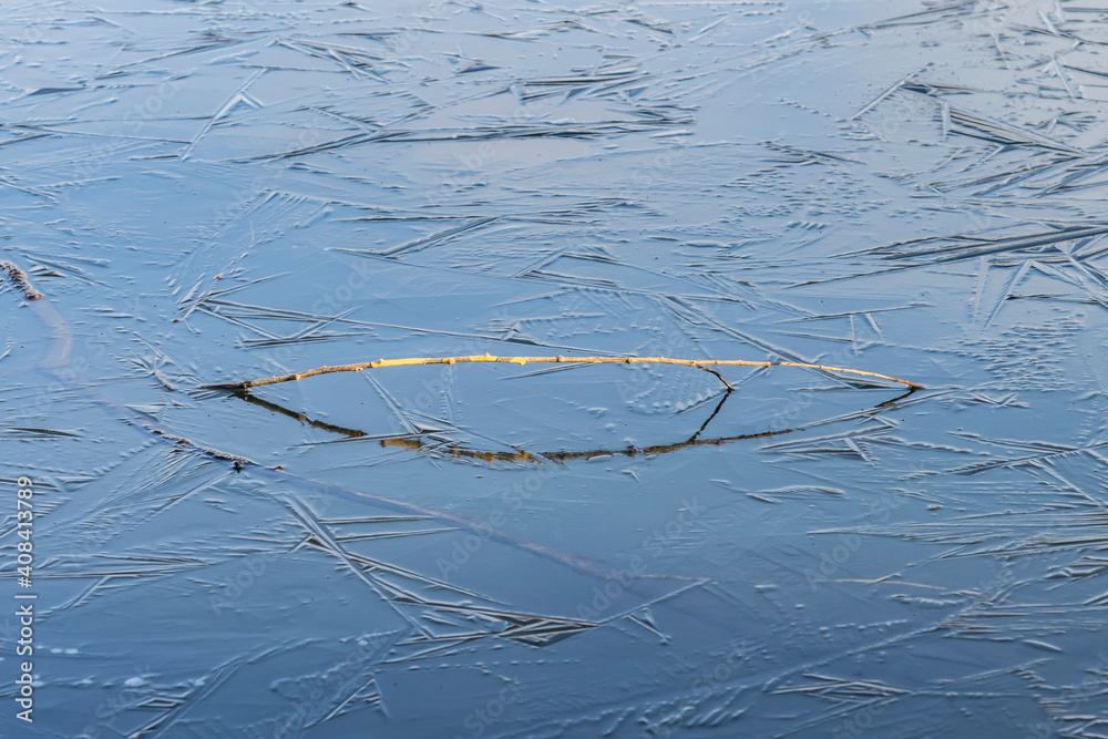 Seasonal background with frozen water. Melting ice in the spring garden ...