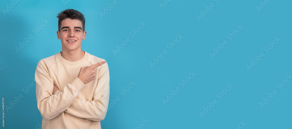 smiling teen boy pointing isolated Stock Photo | Adobe Stock