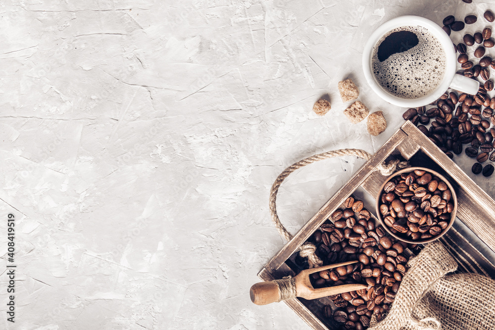 Coffee with coffee beans on grey textured background. Top view with ...