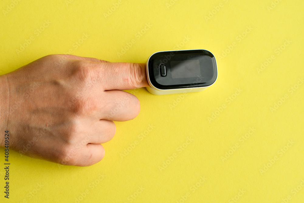 Using pulse oximeter on female finger to test blood oxygen level. Copy ...