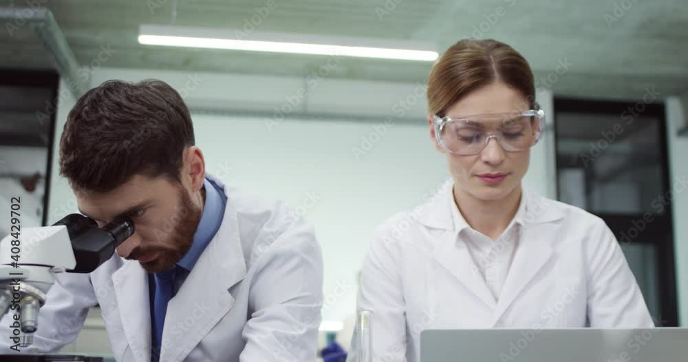 Close up portrait of Caucasian male and female lab doctors scientists ...