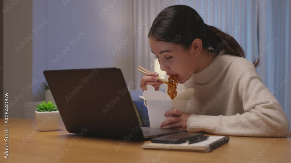 Young attractive beautiful asian female hungry eat instant noodles ...