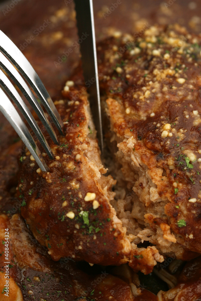 Cross section of hamburger with demi-glace sauce cut in half. close up ...