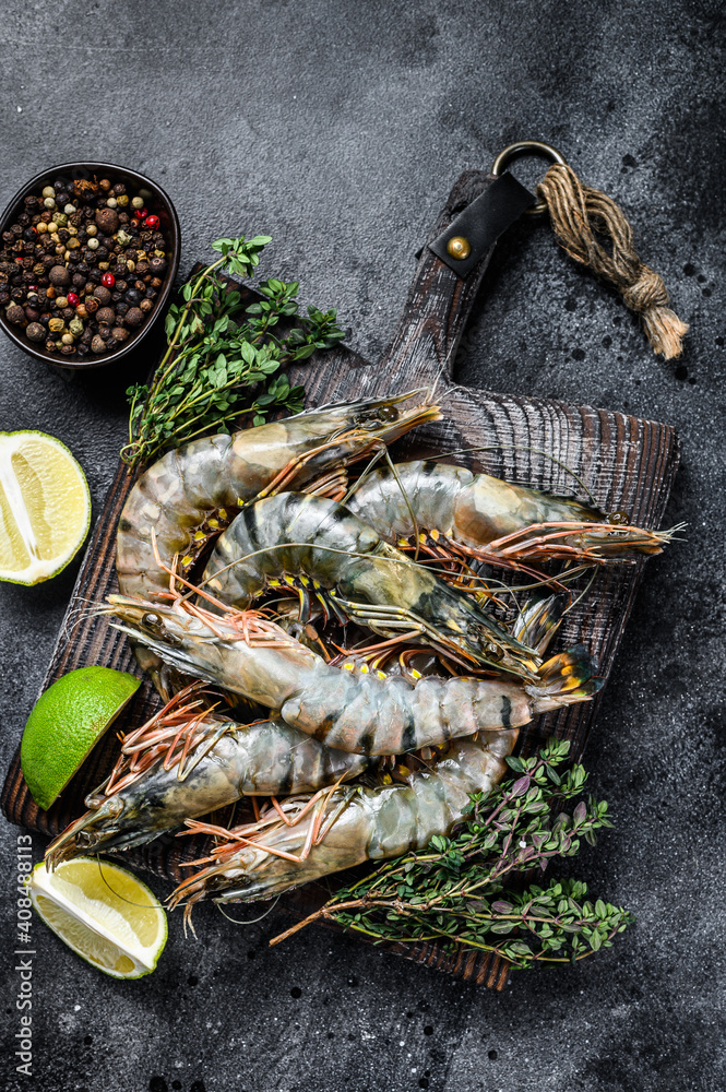 Raw black tiger prawns, shrimps and spices. Black background. Top view ...