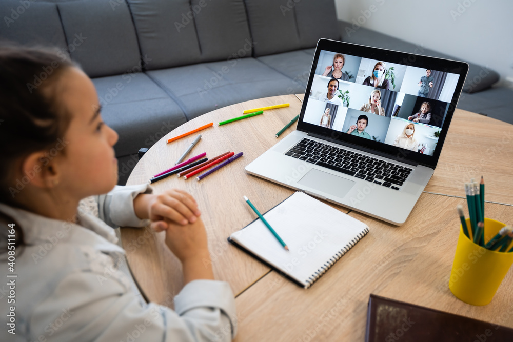 Little girl attending to online e-learning platform class from home ...