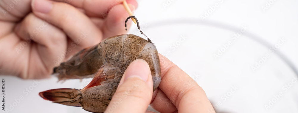 Devein shrimp and pull out intestinal tract line. Stock Photo | Adobe Stock