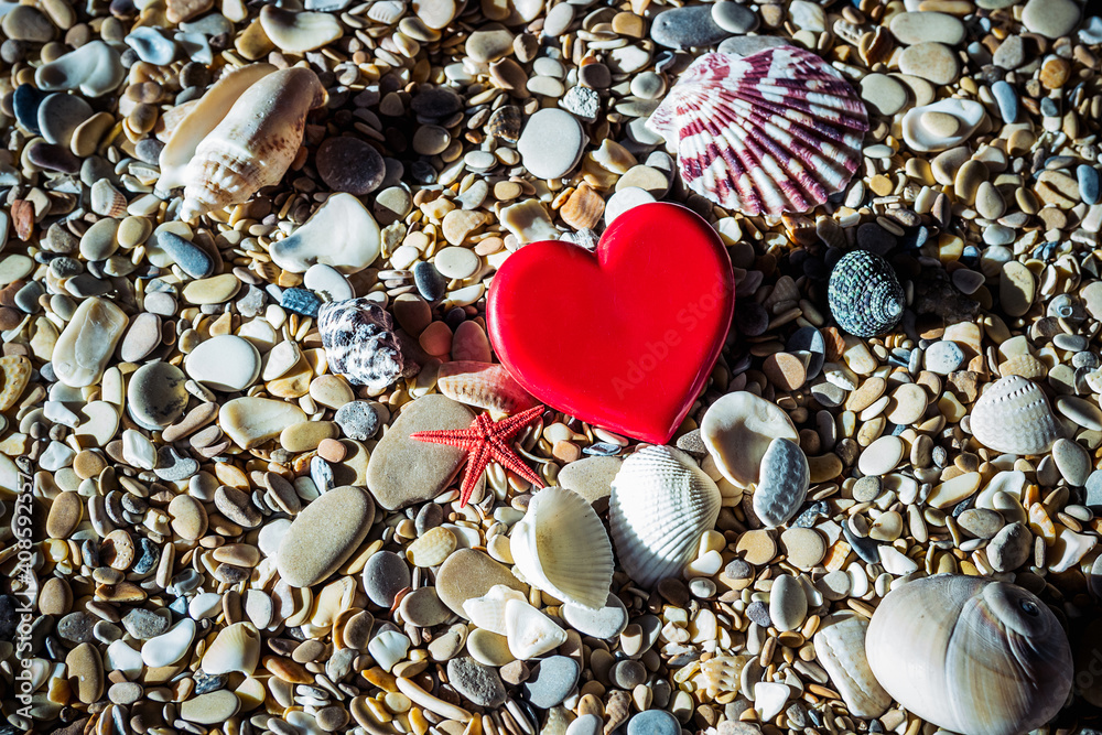Red heart on a beach background. Stock Photo | Adobe Stock