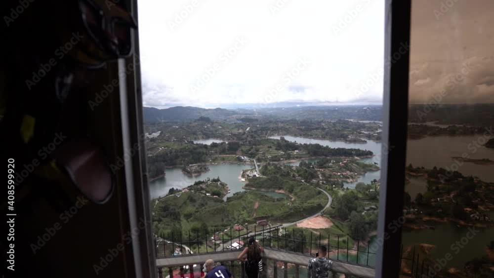 Cinematic shot through a window of Guatape green island, wide, travel ...