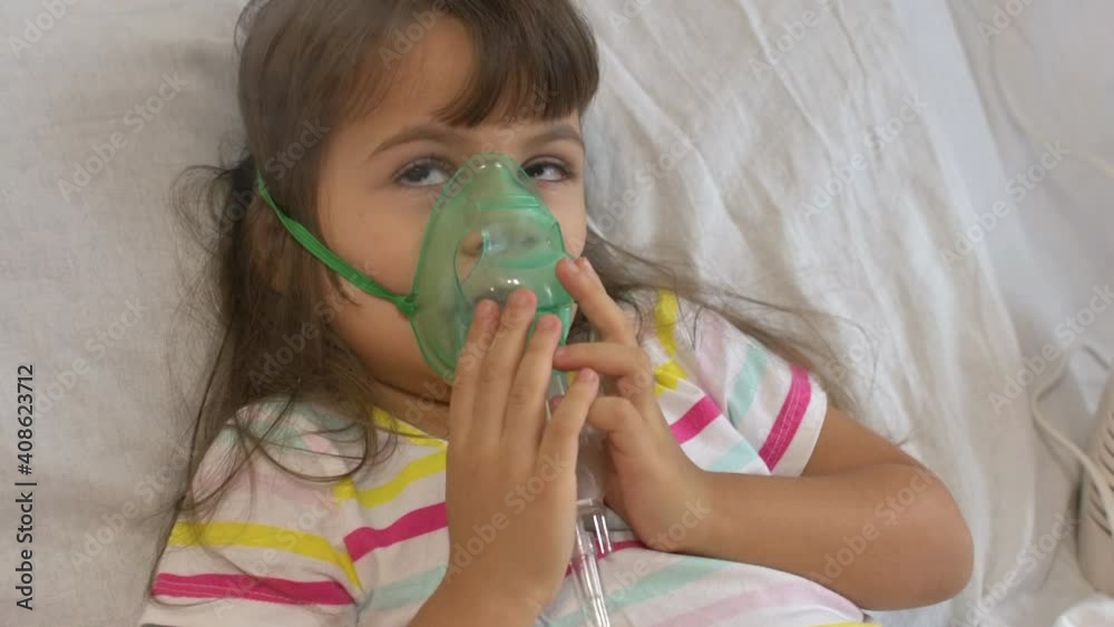 Little kid girl making inhalation with nebulizer at home. Child asthma ...