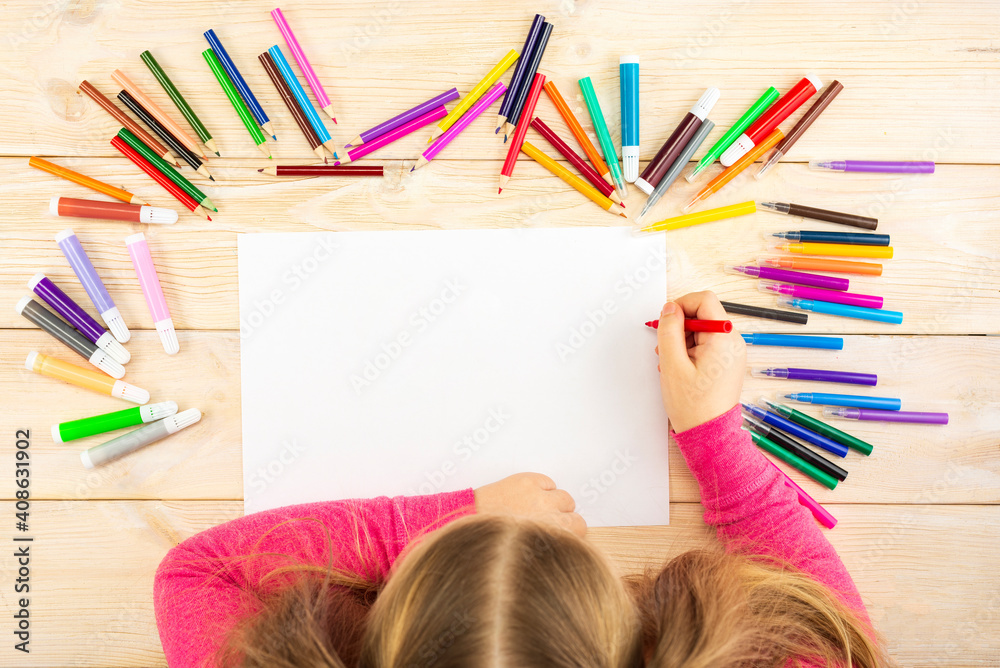 Little girl prepares to paint on a blank sheet of paper. Drawing is ...
