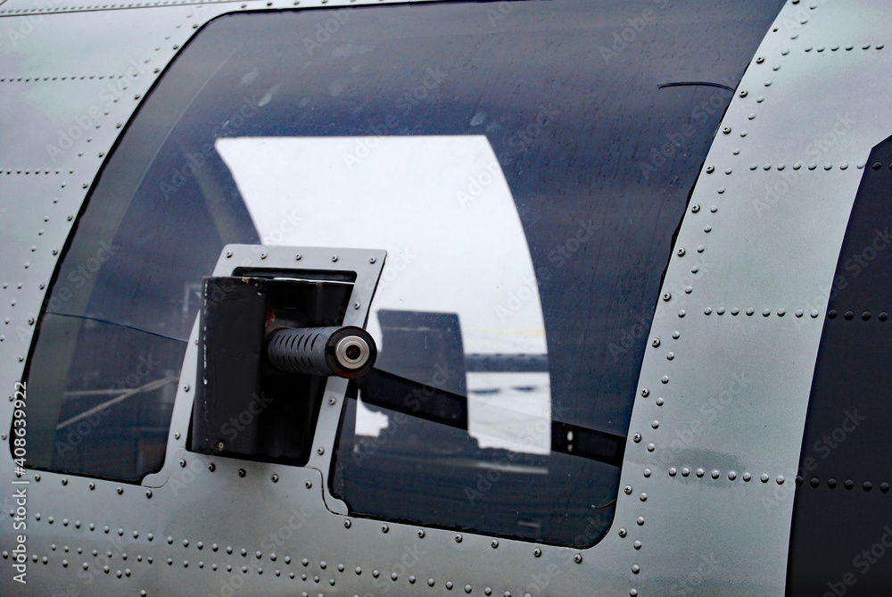 Waist gun port sporting a 50 caliber machine gun on a B-17G flying ...