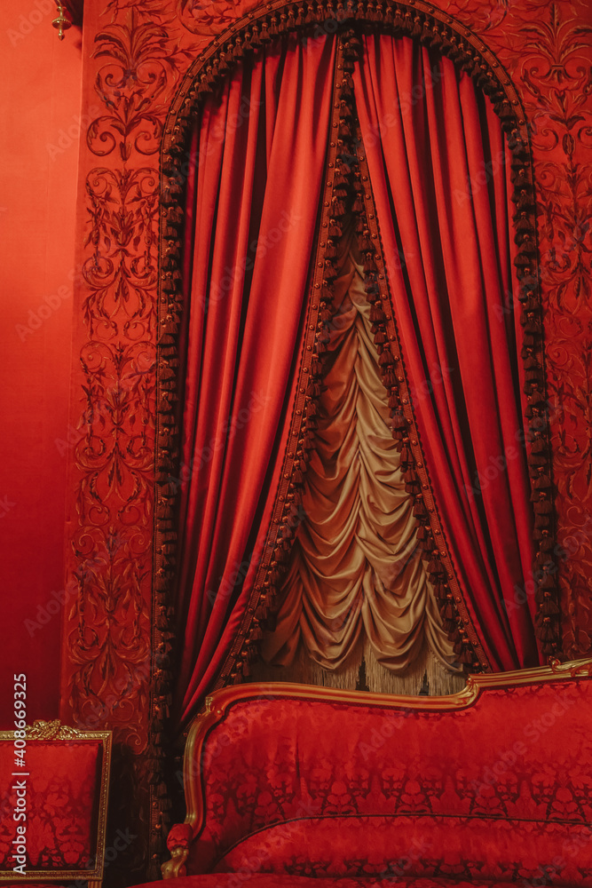 Red curtains and part of the interior with patterns. The luxurious ...