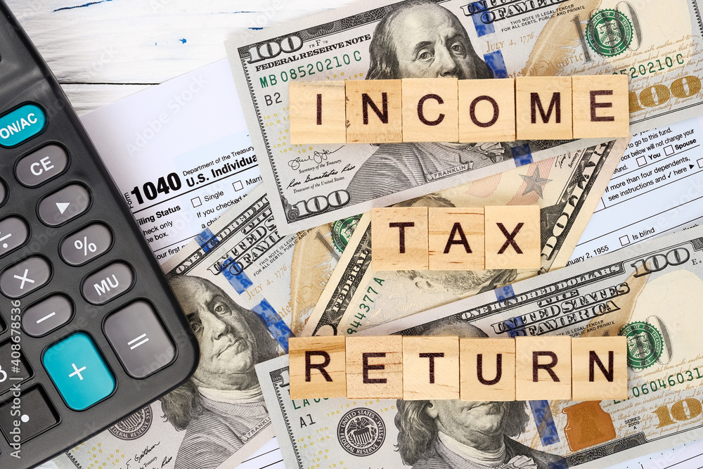 Personal income tax form 1040, dollar bills, calculator. Tax payment ...