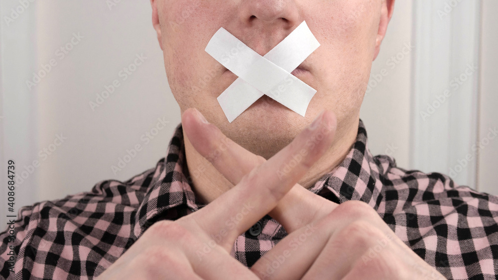 A man with a plaster on his mouth, sealed his mouth with sticky tape ...
