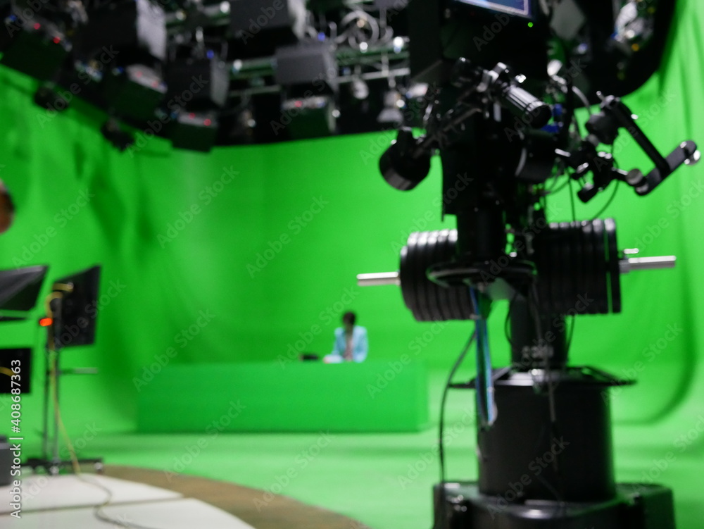 abstract blurred of broadcast camera in studio with virtual greenscreen ...