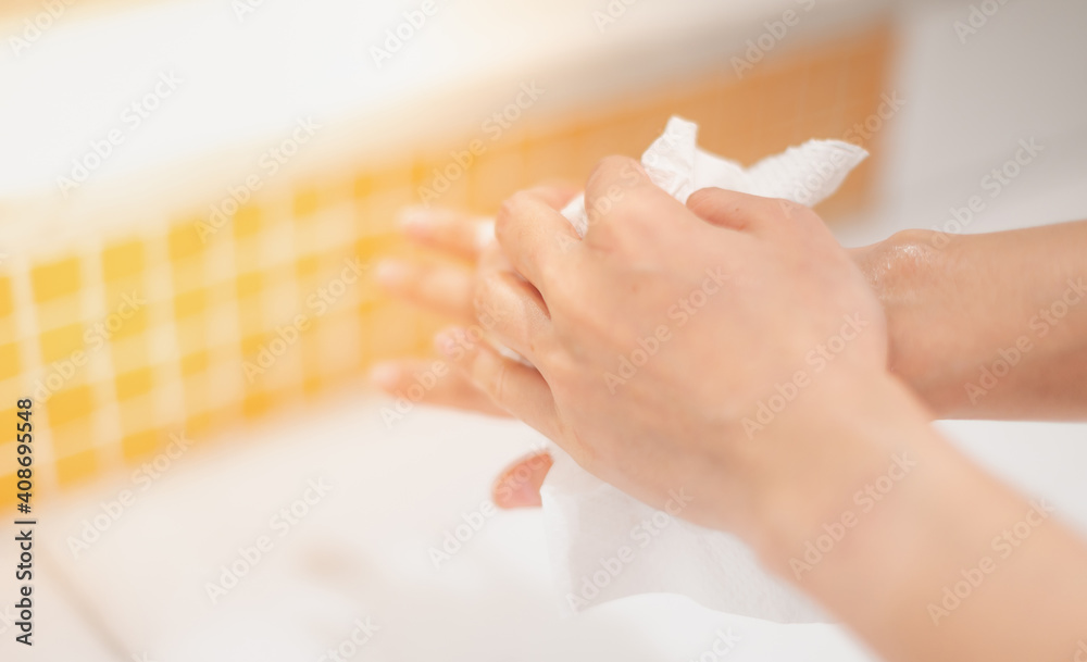 Female hand use antibacterial wet wipes or tissue after washing hand ...