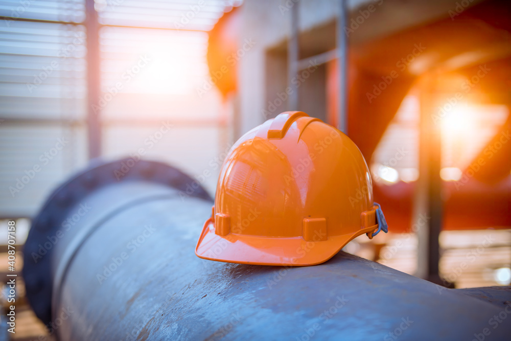 Close up worker helmet use for wearing safety in work putting on pipe ...