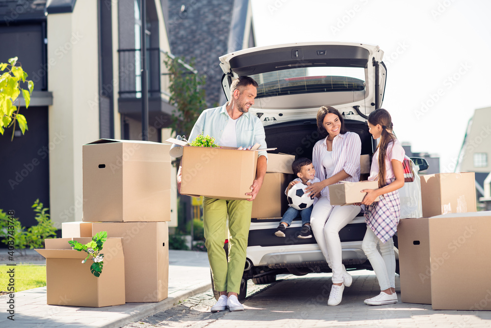 Full size photo of smiling happy family moving dad pack stuff mom and ...