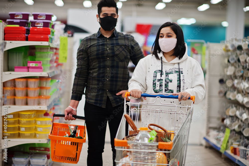 Asian couple wear in protective face mask shopping together in ...