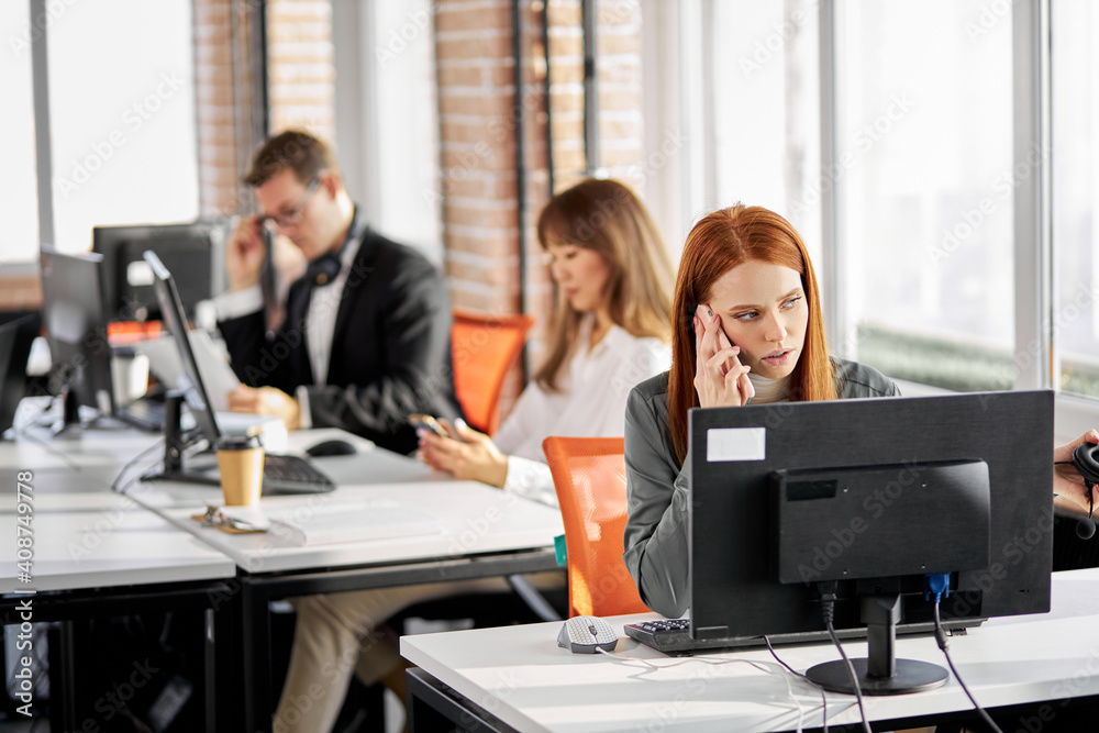 typical working day. business people sitting in modern office and using ...