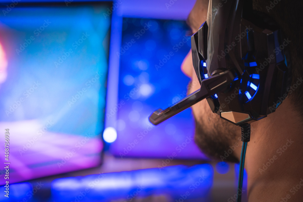 Professional gamer playing video game on his personal computer. Room ...