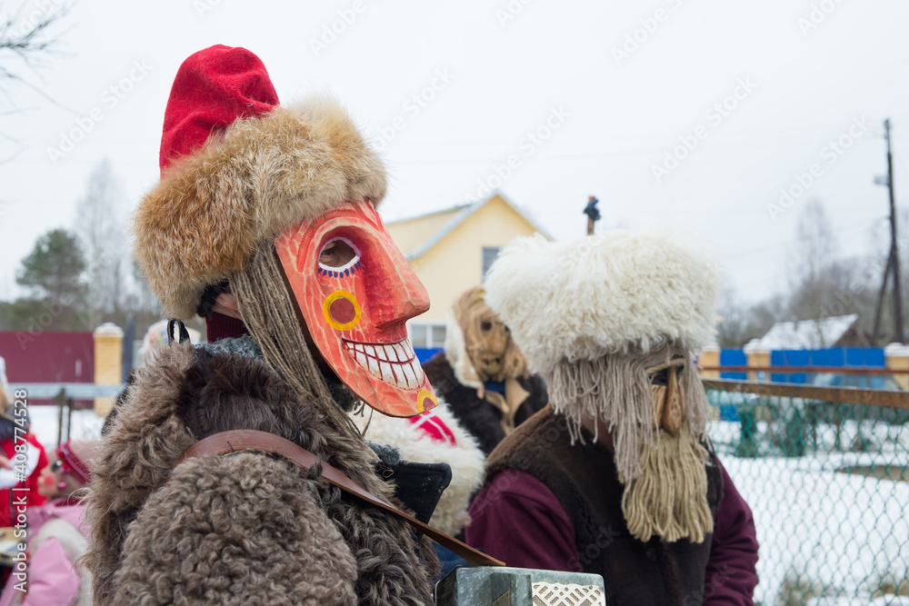 People in demon masks are caroling in a Russian village. folk holidays ...