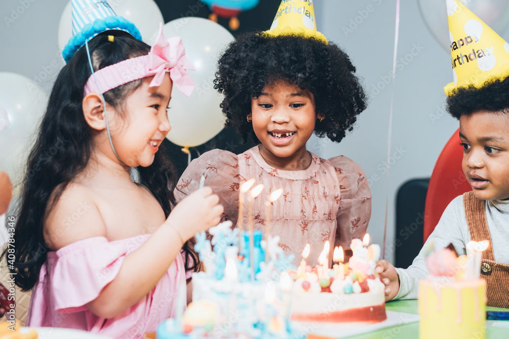 Portrait of multi ethnic group of kids enjoy having birthday party ...