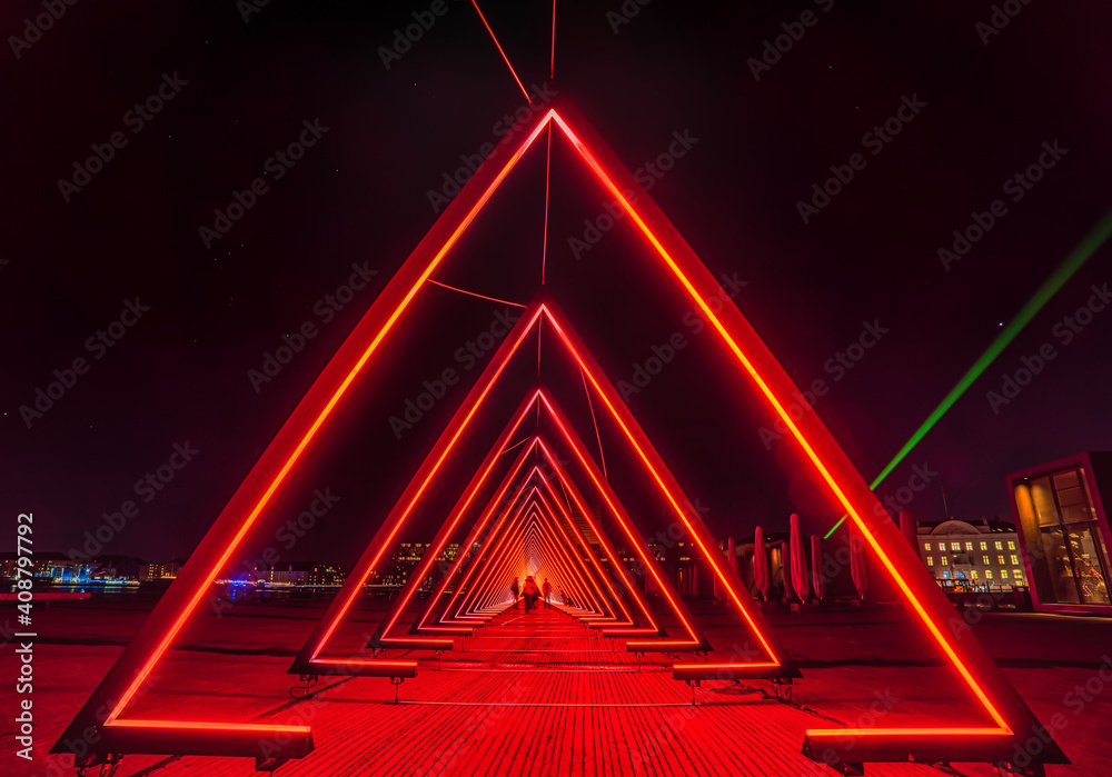 Series of triangular gates of light or intense red light tunnel. The ...