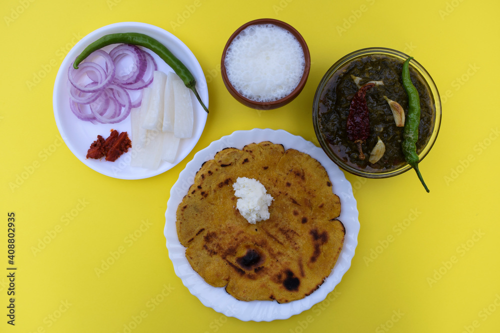 India Makki roti and sarson saag with onion chilly salad and earthened ...