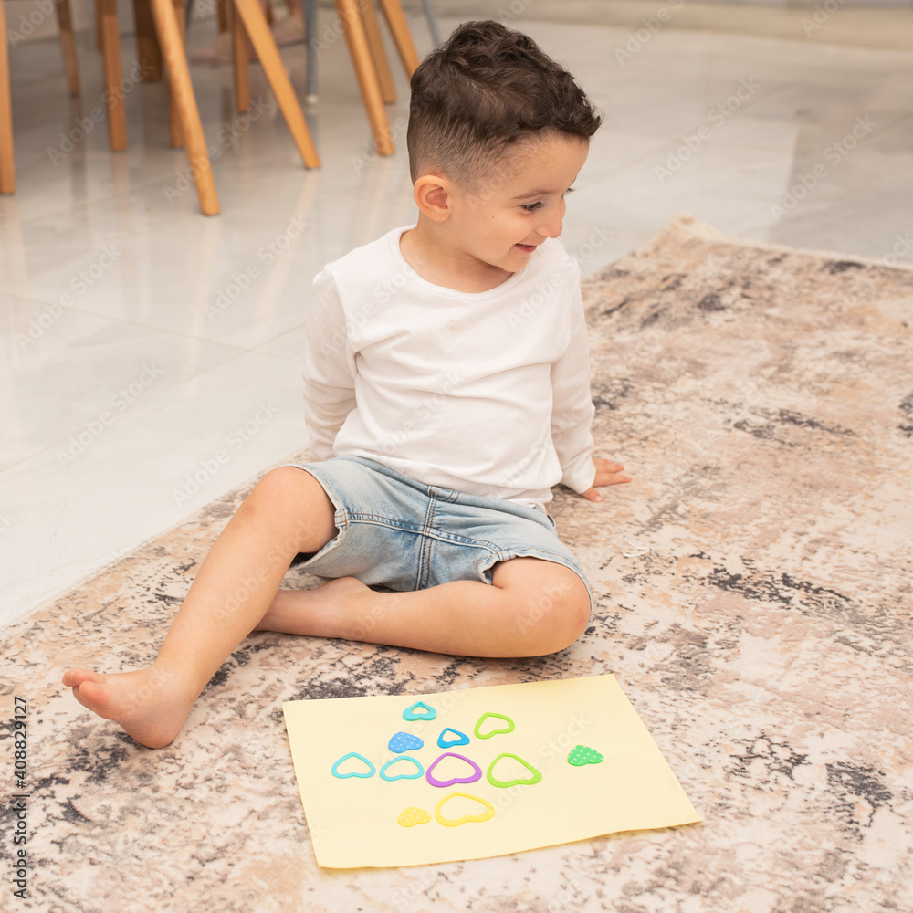 Little Boy making Valentine's Day crafts and cards, at home, in the ...