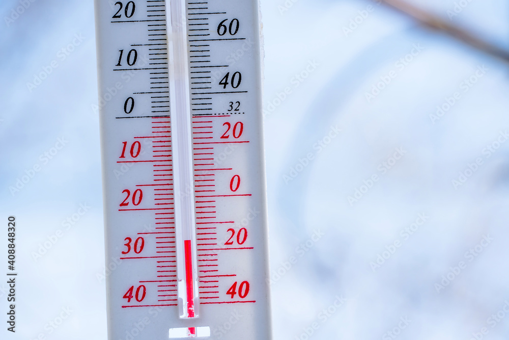 The thermometer lies on the snow in winter showing a negative ...