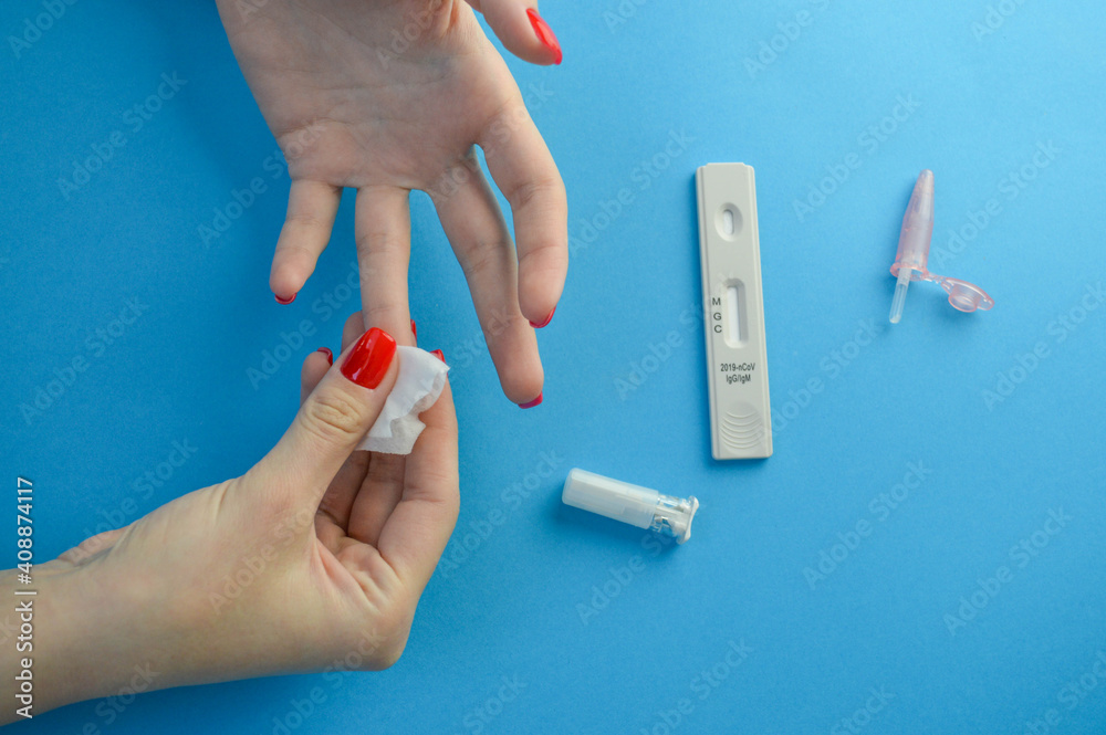 preparing a finger for a blood test. sterile analysis. wiping your ...