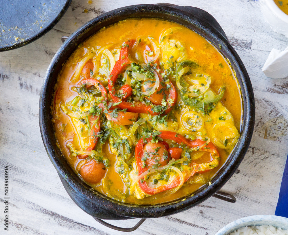 Brazilian seafood fish stew ( moqueca) cooked in a terracotta casserole ...