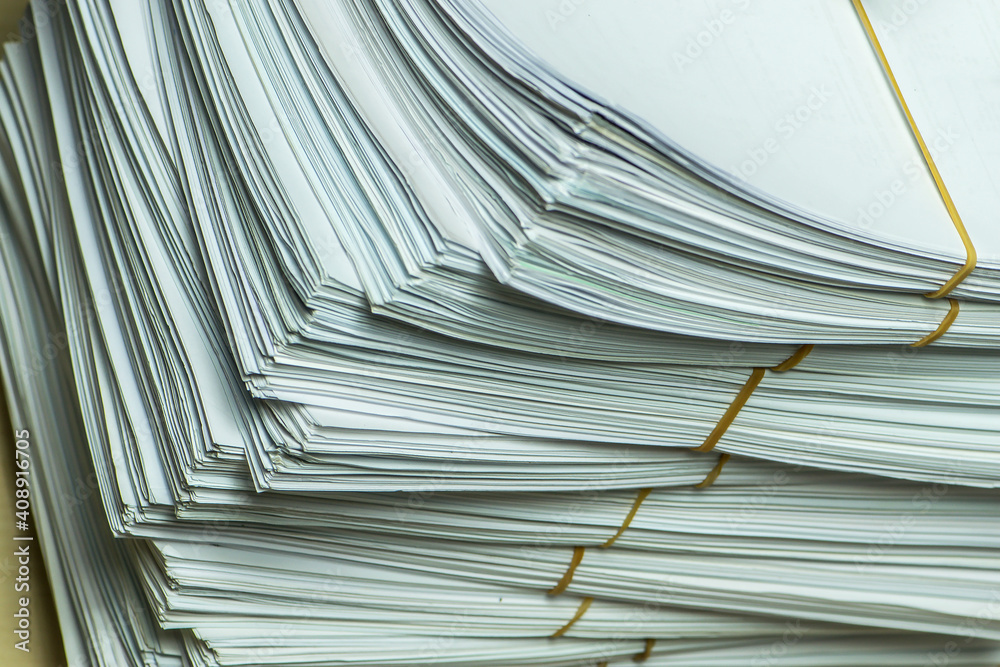 bundles bales of paper documents. stacks packs pile on the desk in the ...