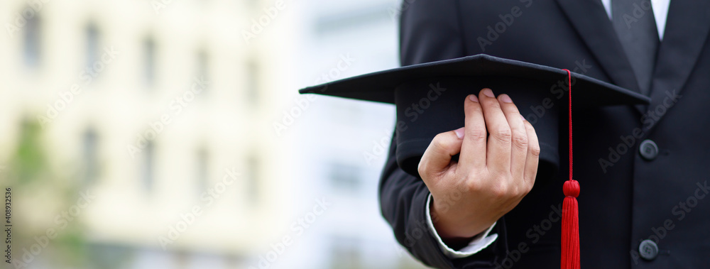 Foto de graduates ,close up student holding hats and tassel red in hand ...