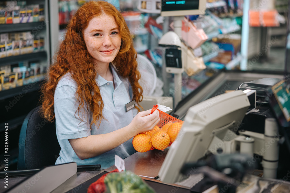 Cashier on checkout in supermarket Stock Photo | Adobe Stock