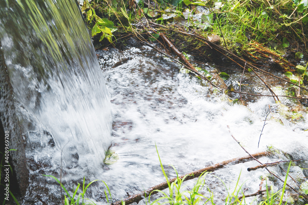 small natural waterfall in the forest in spring summer autumn ...