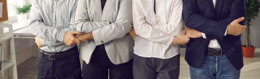Team of male and female business people standing together in office ...