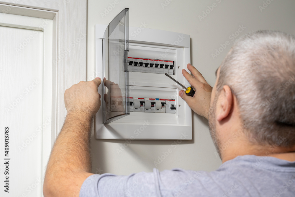 Electricity distribution box. Fuse box. man doing electrical work Stock ...