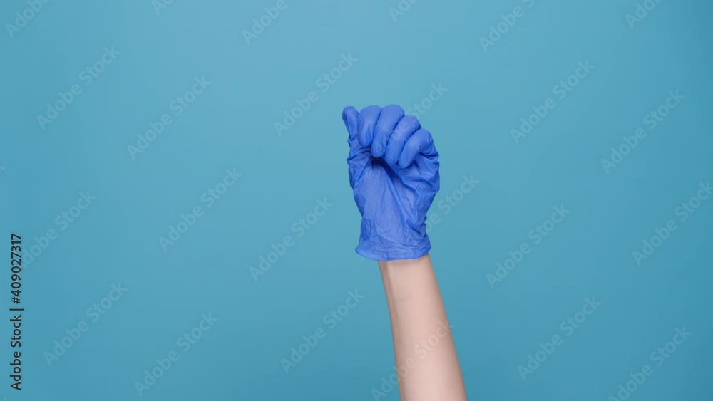 Close up of female hand in medical protection latex gloves knock knock ...