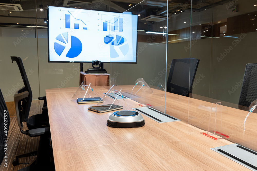 Video conference meeting room with clear acrylic sheet separates the ...