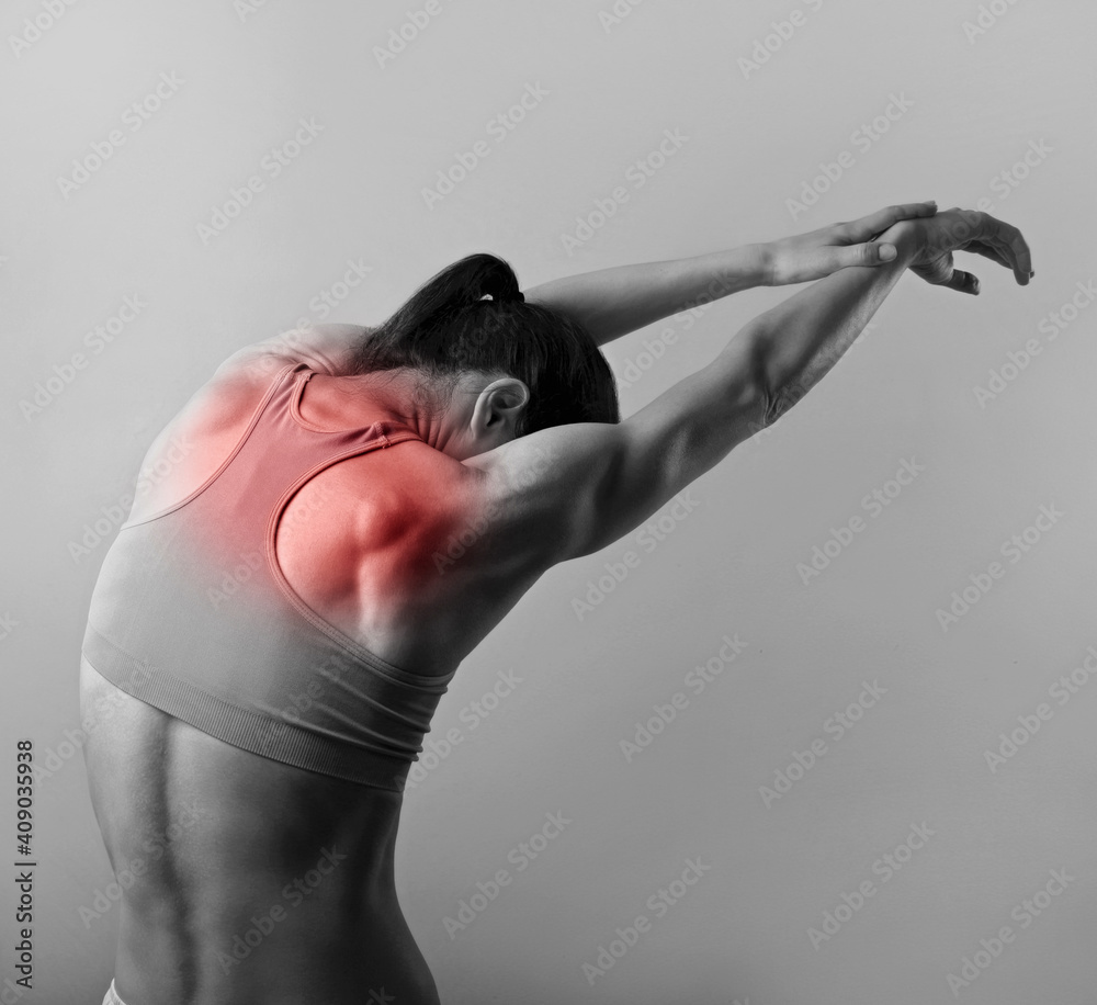 Strong sporty woman suffering from pain in shoulder and stretching of ...