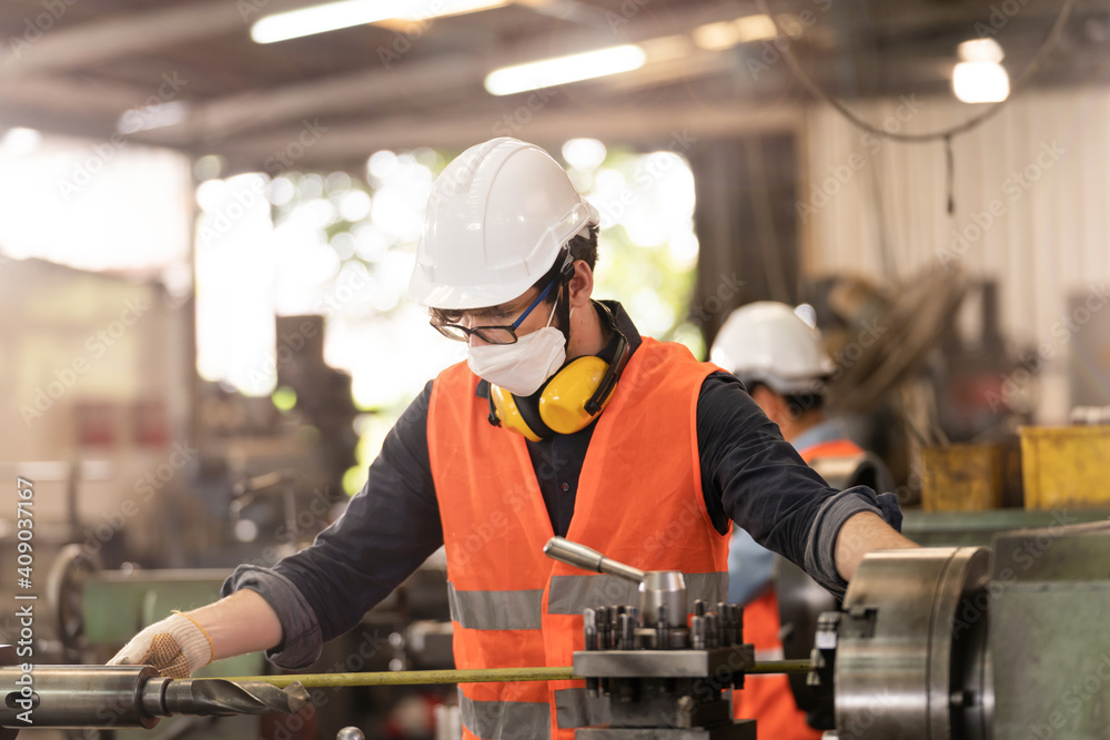 workers factory man wearing face mask and working at heavy machine ...