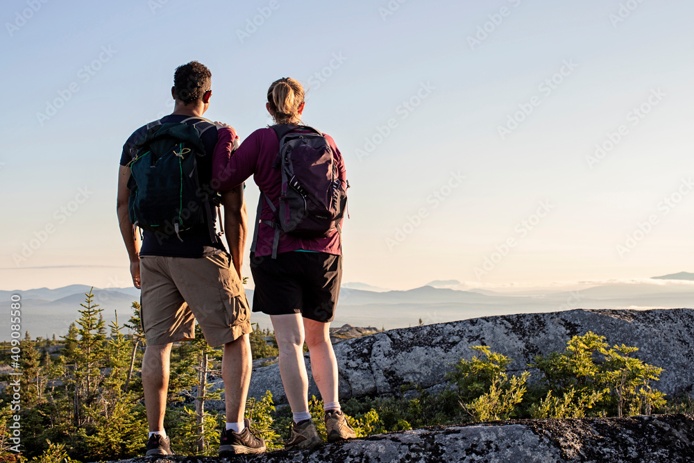 Couple stand together watching view from top of Moxie Bald Mountain ...