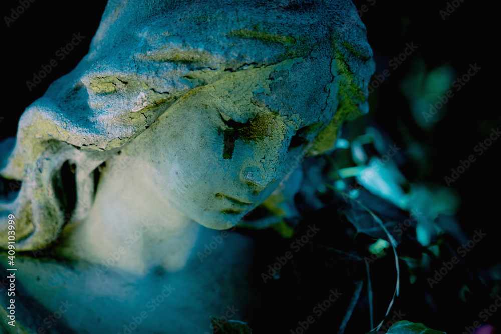 Death concept. An ancient stone statue of crying angel with tears in ...