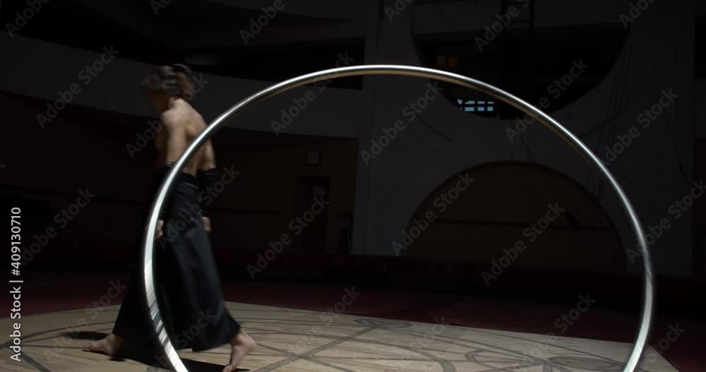 Wheel gymnast is pushing the hoop on stage, walking away, circus, 4k ...