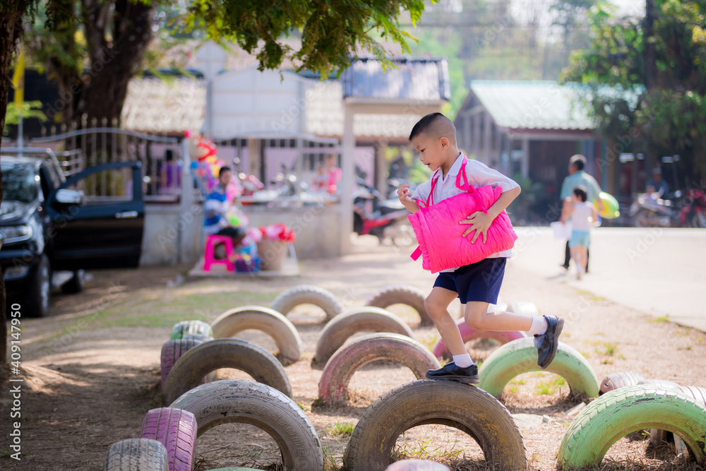 Portrait of adorable Asian kid running jumping alone with happy face ...